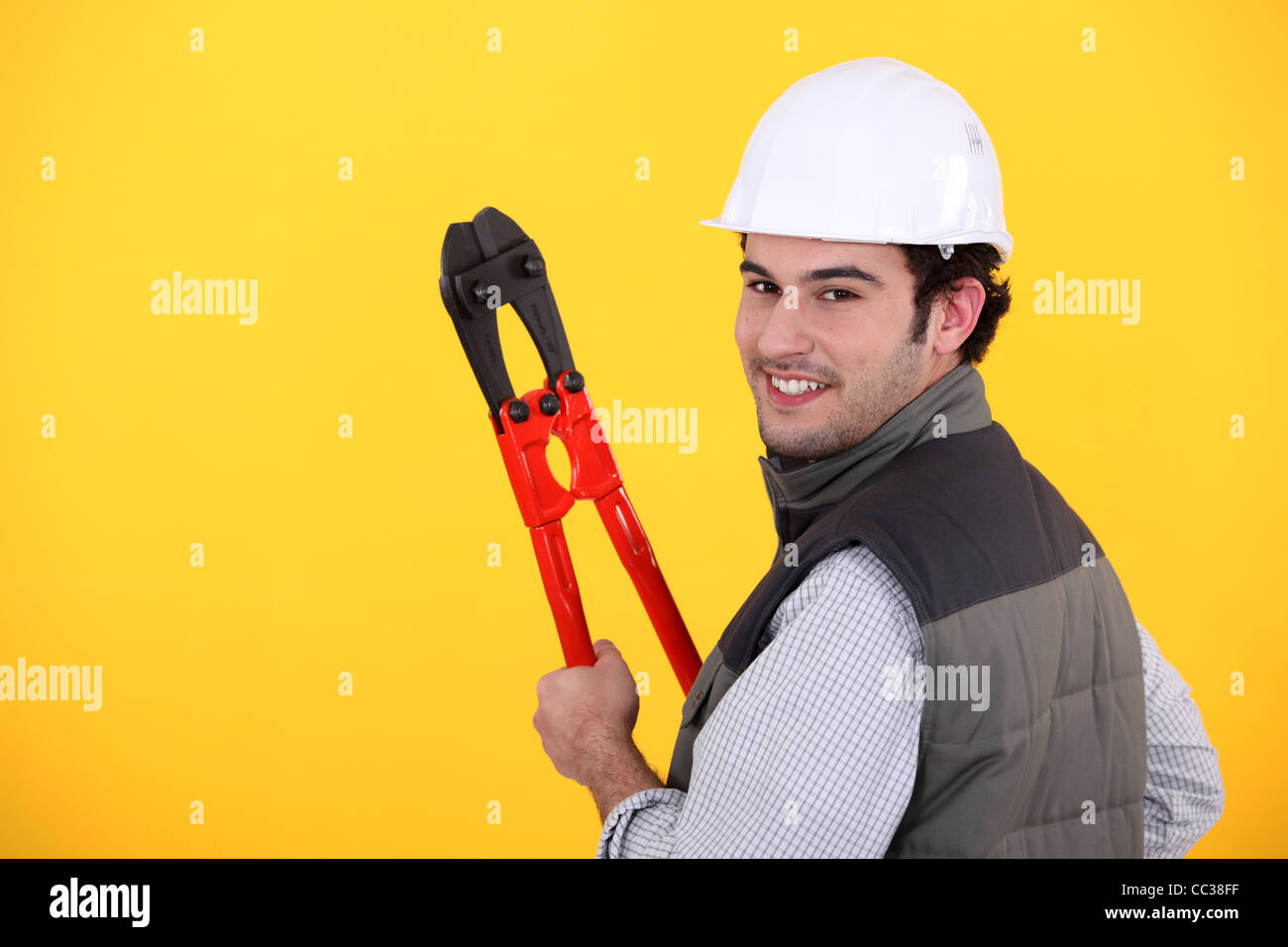 Happy workman on yellow background Stock Photo - Alamy