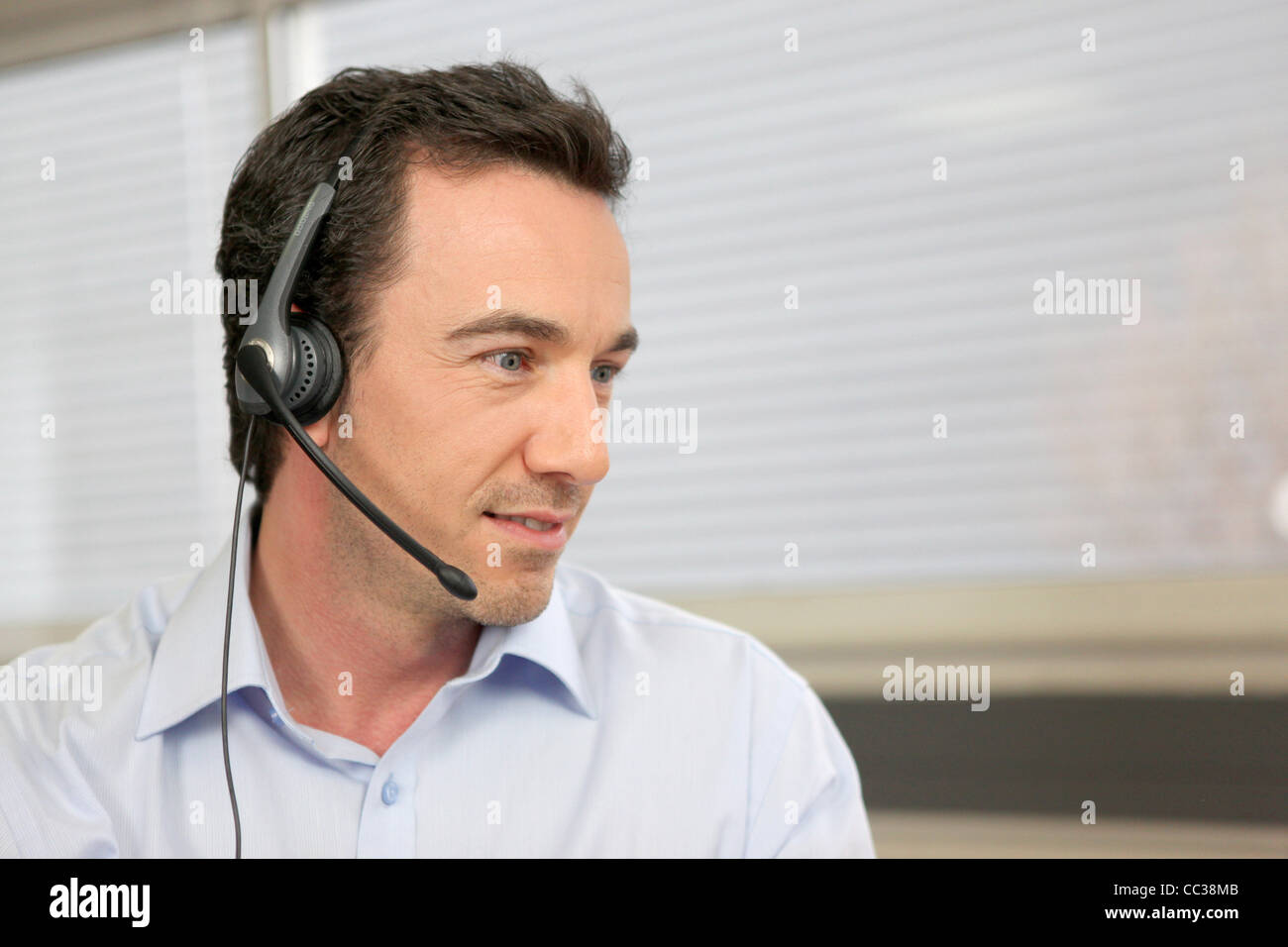Office worker with headset Stock Photo - Alamy