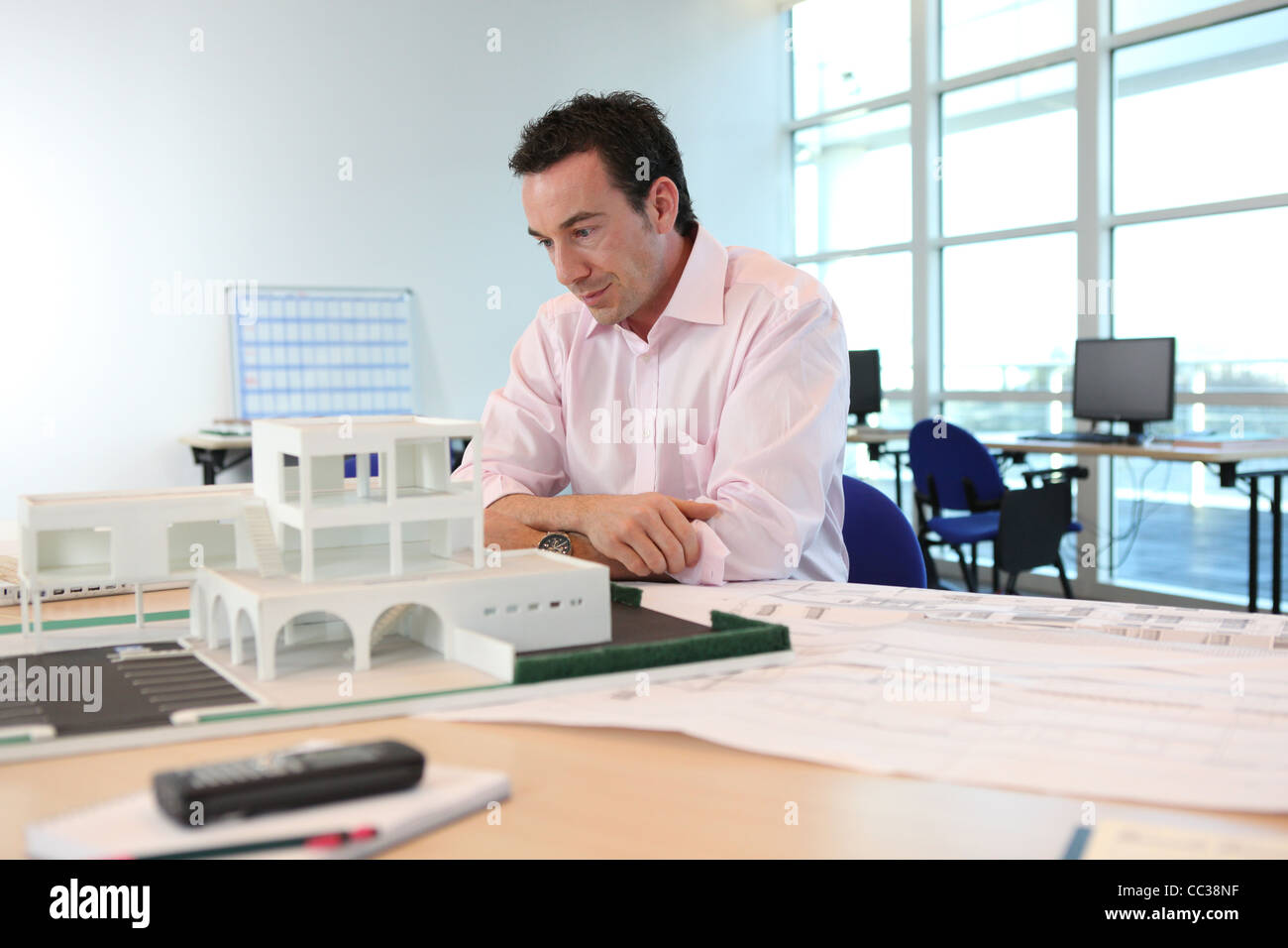 Architect with a model of a building Stock Photo - Alamy