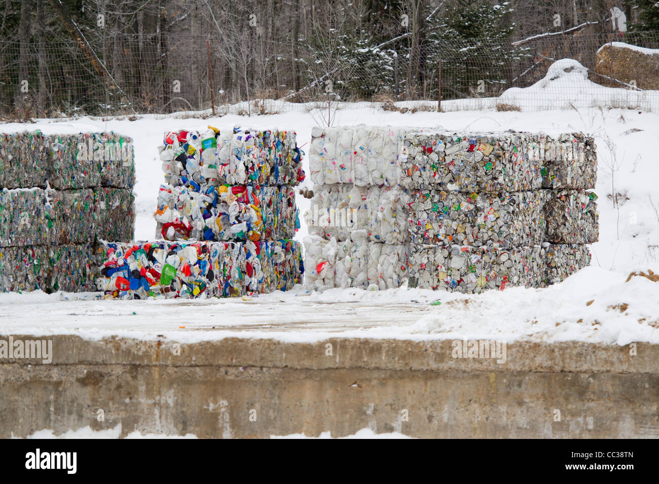 Stacks of baled or cubed recyclables including cans and plastic bottles ...