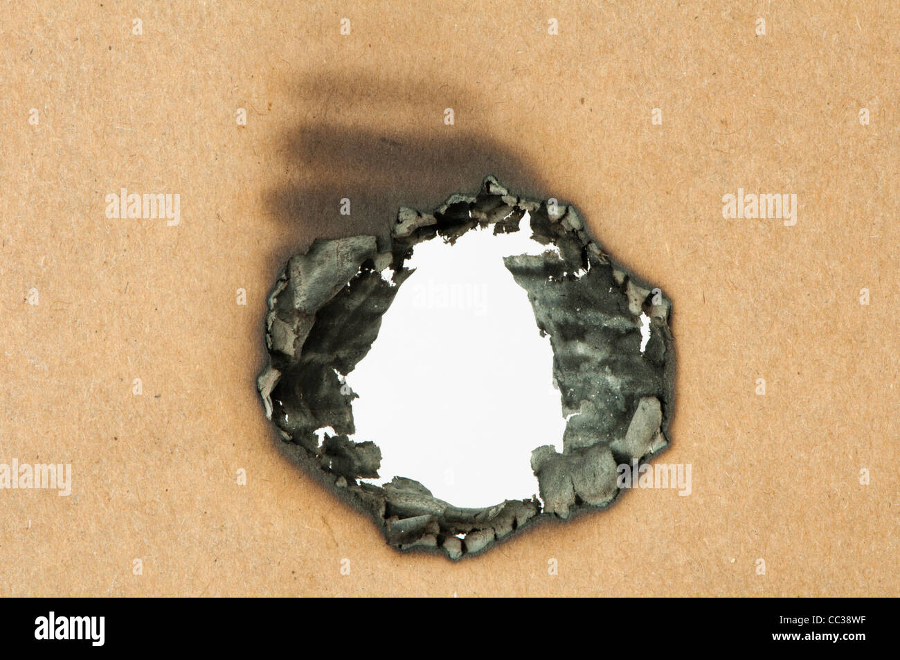 Burned paper and close up hole Stock Photo - Alamy