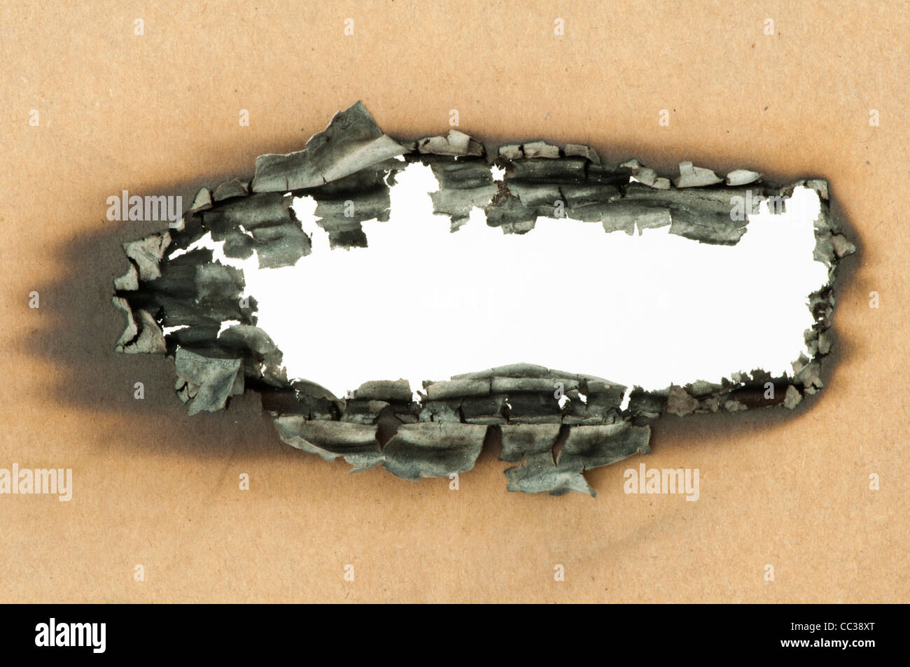 Burned paper and close up hole Stock Photo - Alamy