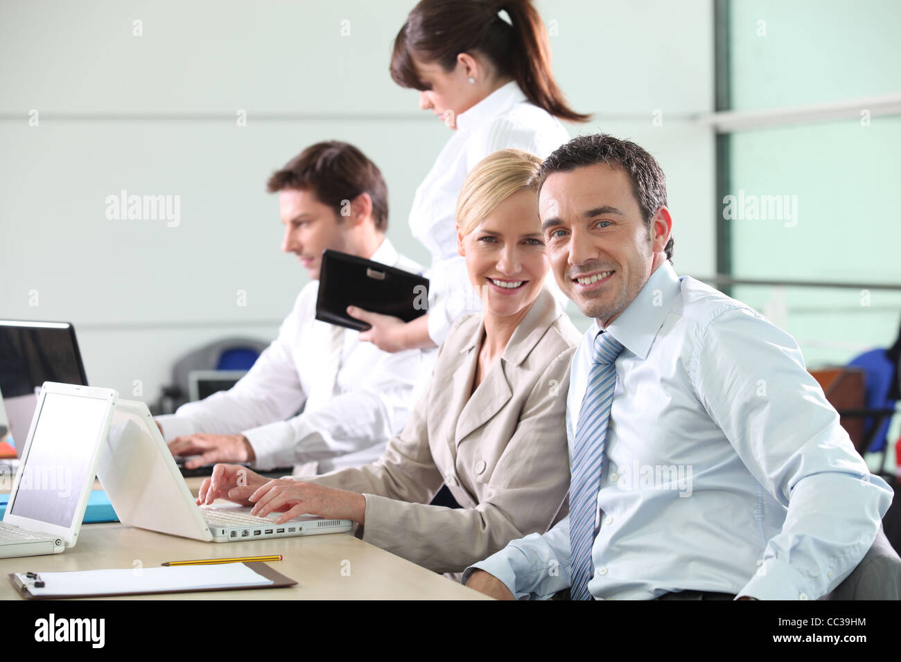 Colleagues working in an office Stock Photo - Alamy