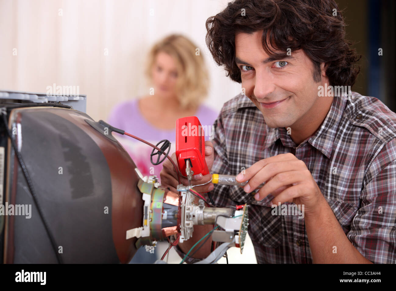 Man repairing television set Stock Photo - Alamy
