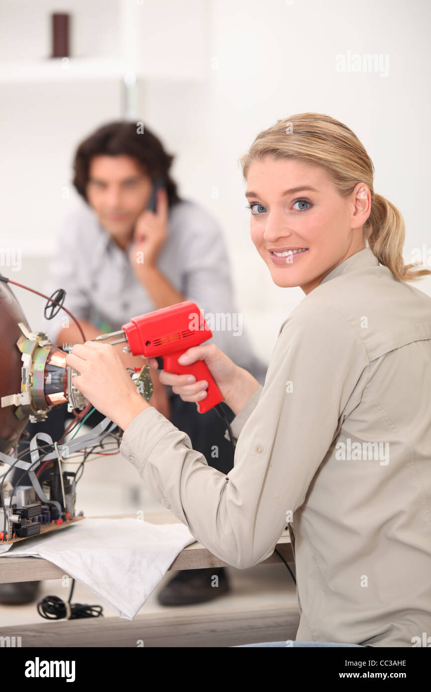 A woman fixing a TV Stock Photo - Alamy