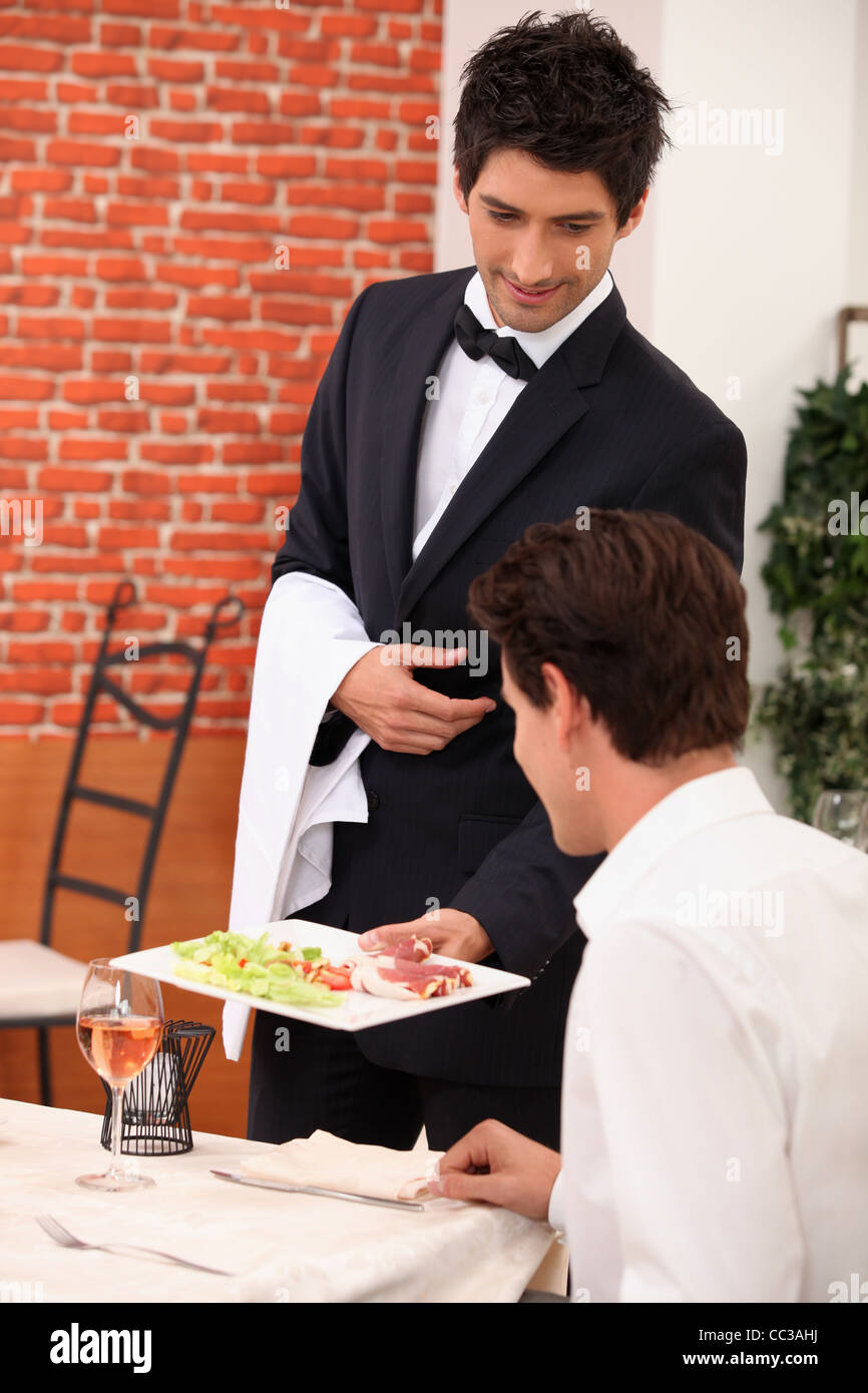 Smart waiter in restaurant Stock Photo - Alamy