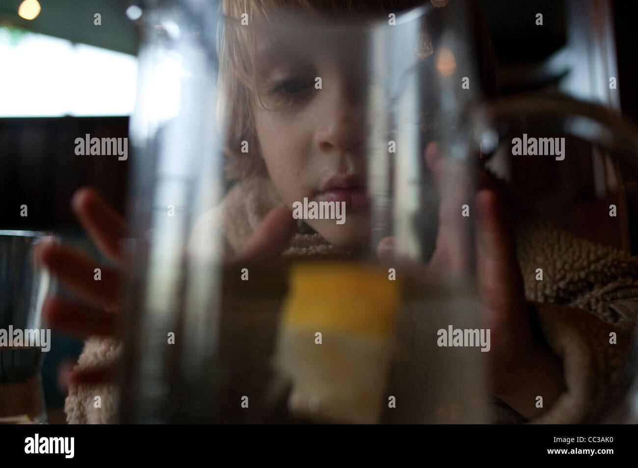 Little boy playing behind his glass Stock Photo - Alamy