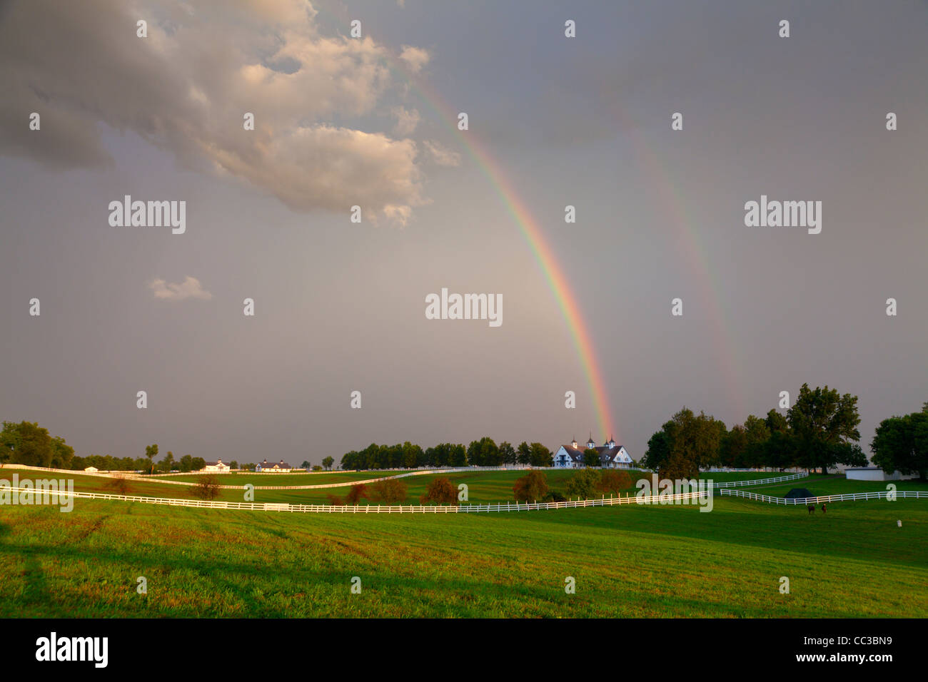 Rainbow over a horse farm Stock Photo - Alamy