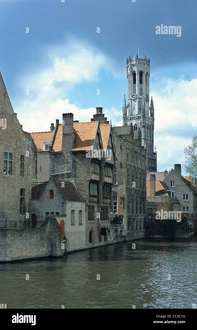 Houses by the canal with Belfry tower in the background, Bruges ...
