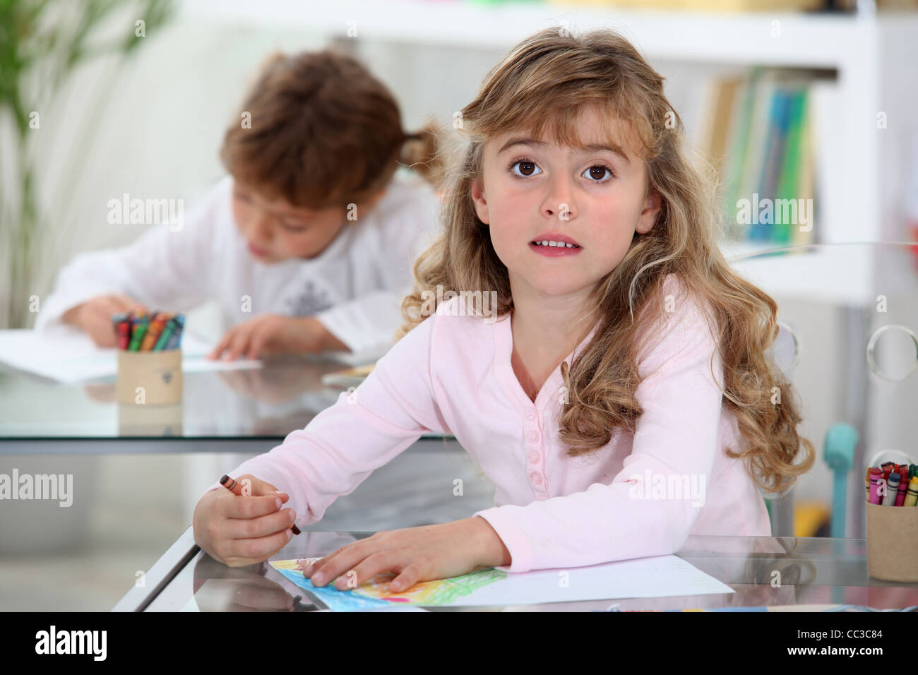 two kids studying in a classroom Stock Photo - Alamy
