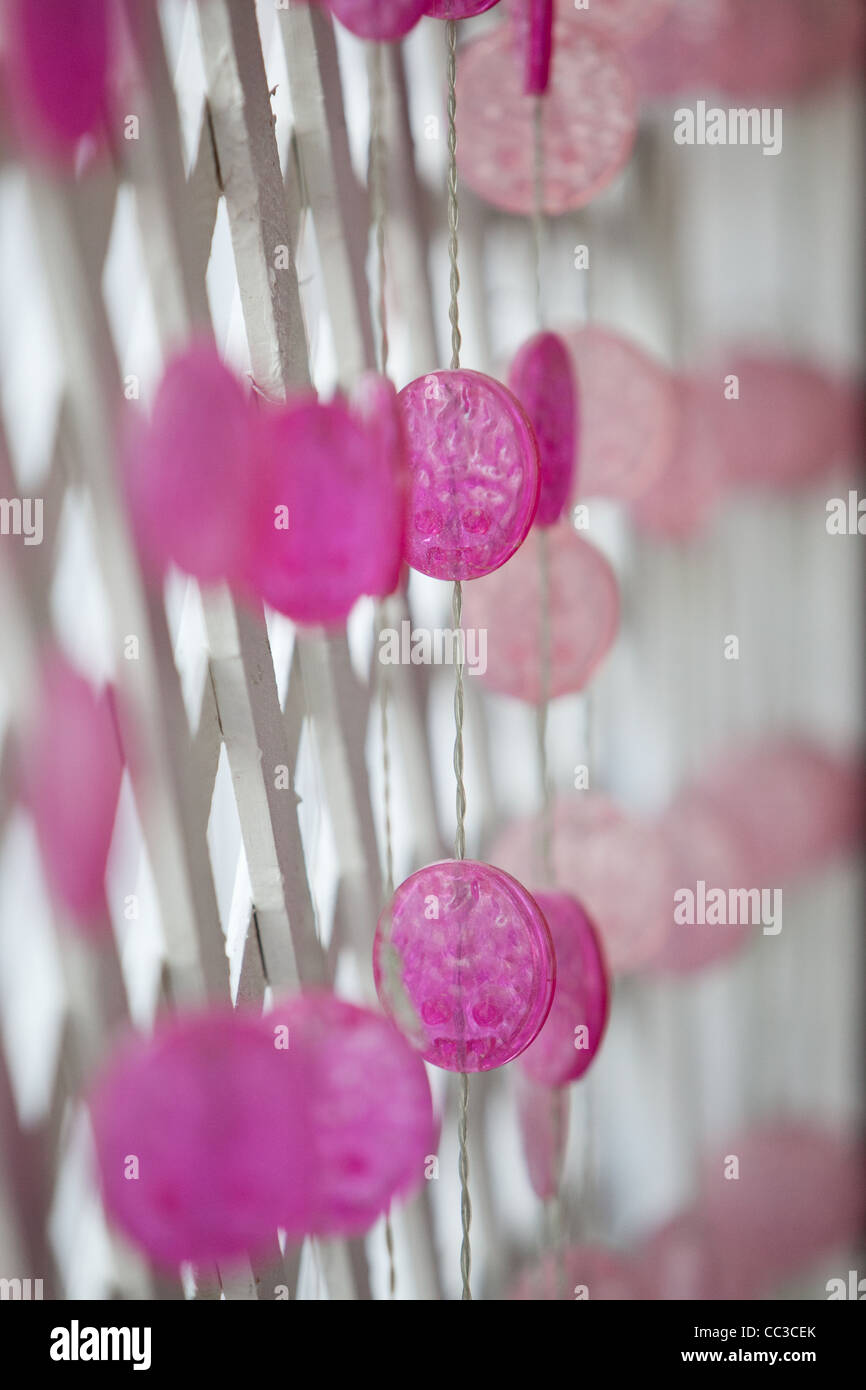 Pink light decorations on a white fence Stock Photo - Alamy