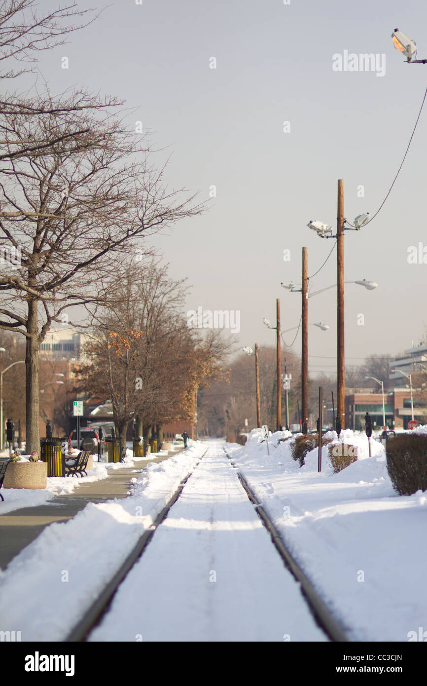 Winter train tracks into horizon in a city and town Stock Photo - Alamy