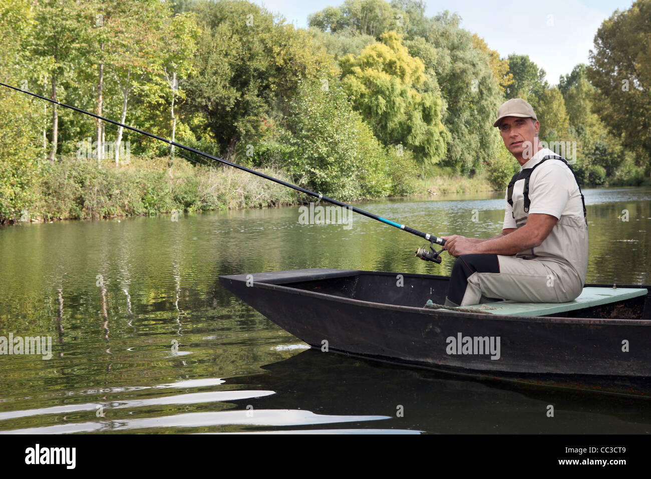 Man fishing on a lake Stock Photo - Alamy