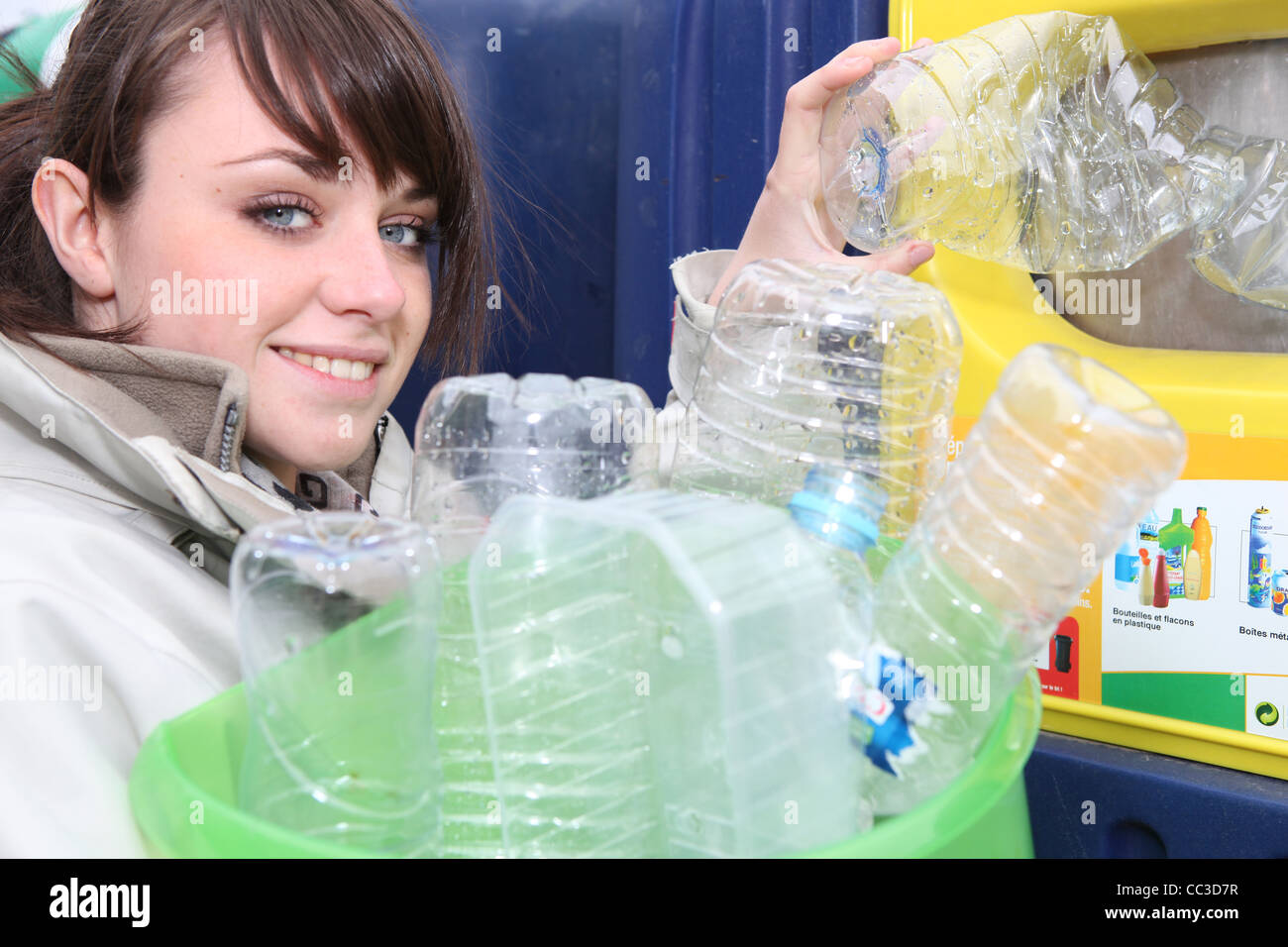 Woman recycling plastic bottles Stock Photo - Alamy