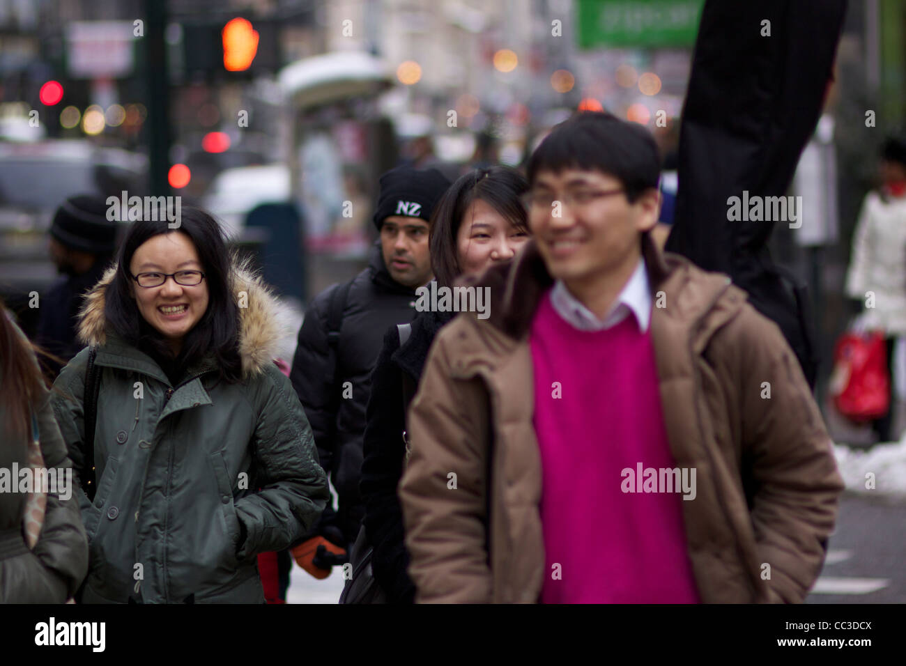 Asian persons walking nyc street smiling happy Stock Photo - Alamy