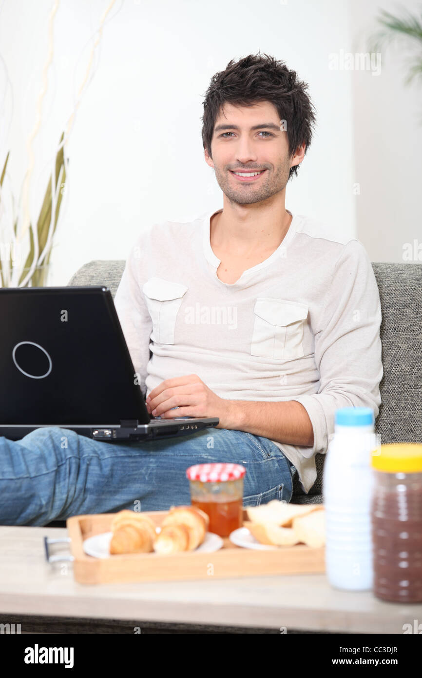 man having breakfast on sofa Stock Photo - Alamy