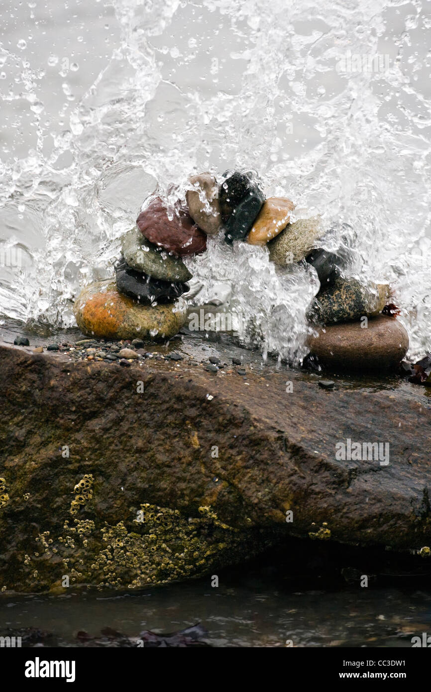 Balanced Stones rock arch at the seaside being destroyed by the high ...