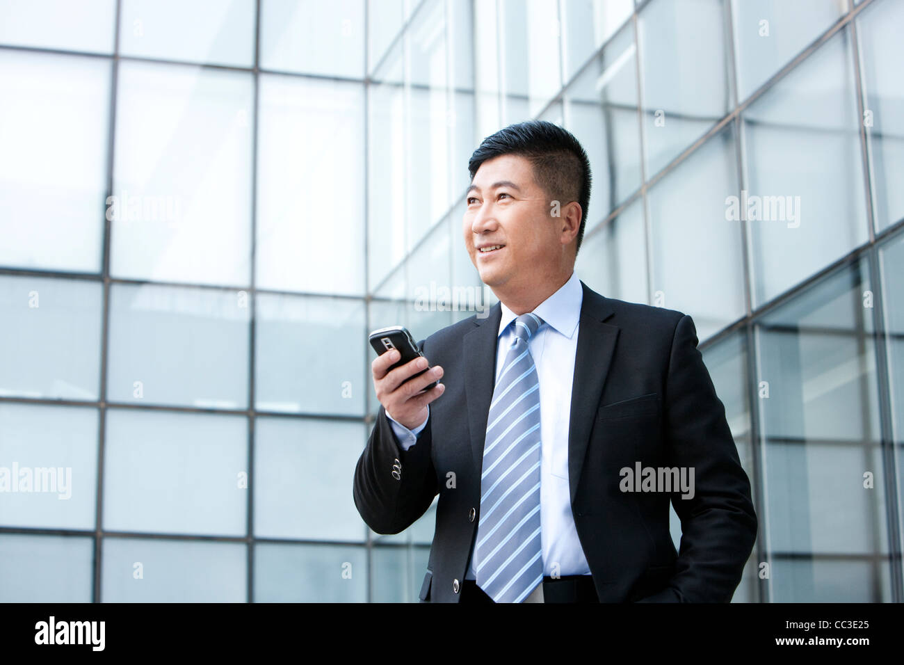 Businessman checking his phone Stock Photo - Alamy