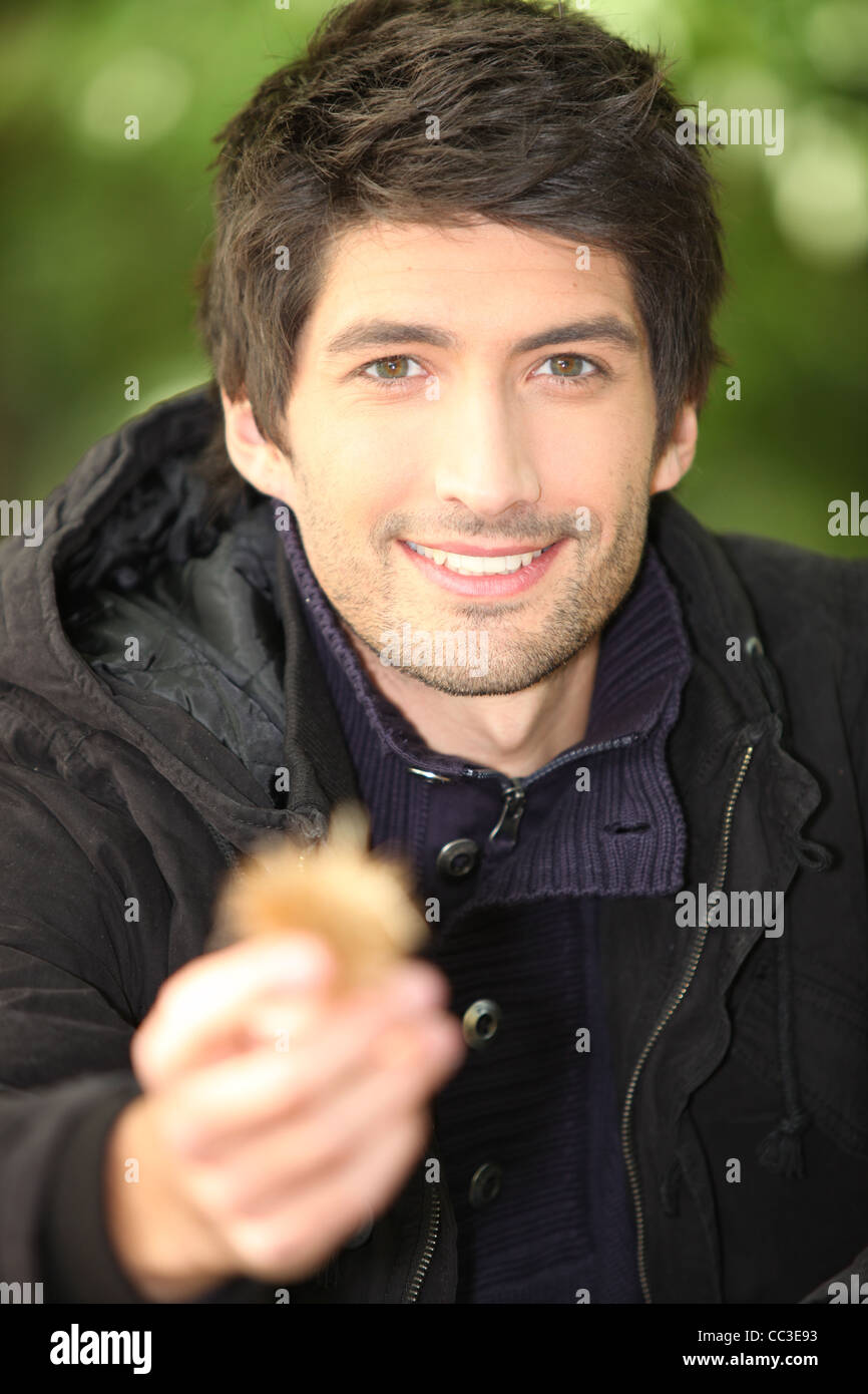 a young man giving something Stock Photo - Alamy