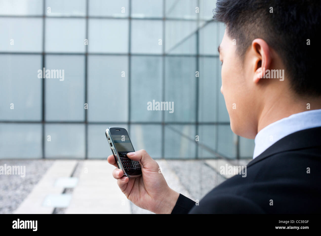 Businessman checking his phone Stock Photo - Alamy