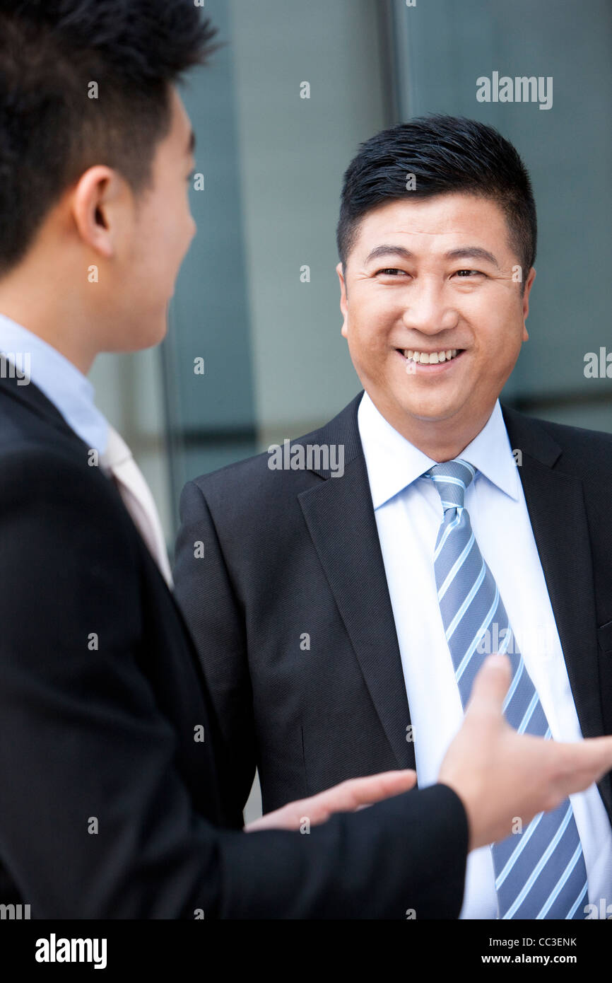 Standing gesturing communication leadership building exterior hi-res ...