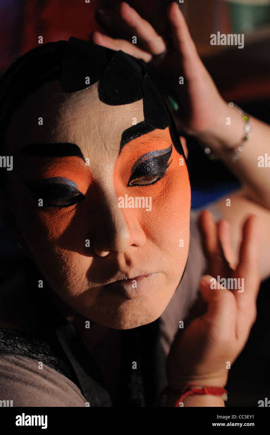 chinese opera actress is painting her face backstage Stock Photo - Alamy