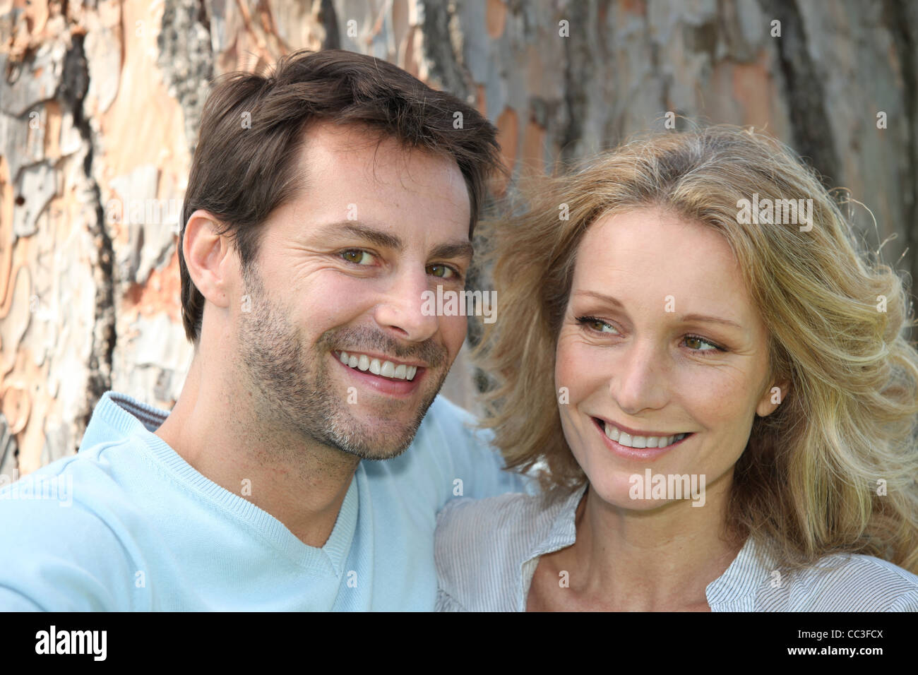 Couple by tree Stock Photo - Alamy