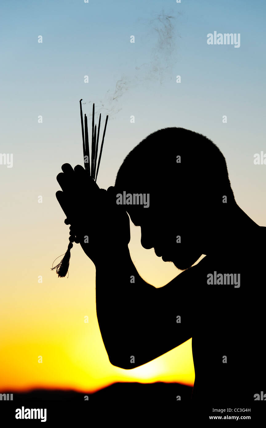 Single man praying hi-res stock photography and images - Alamy