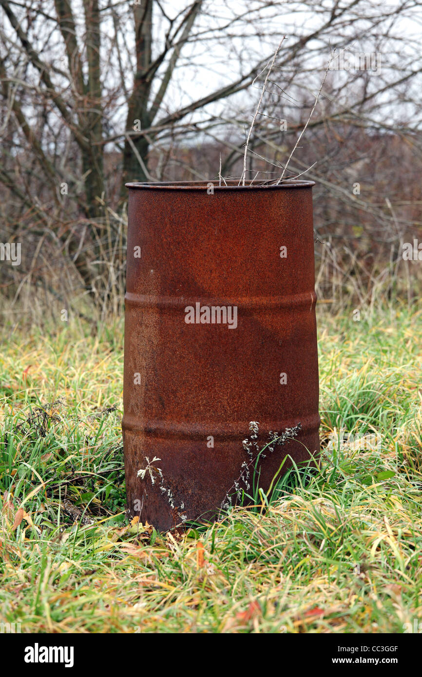 А rusty barrel in the autumn grass. Focus on a barrel Stock Photo - Alamy