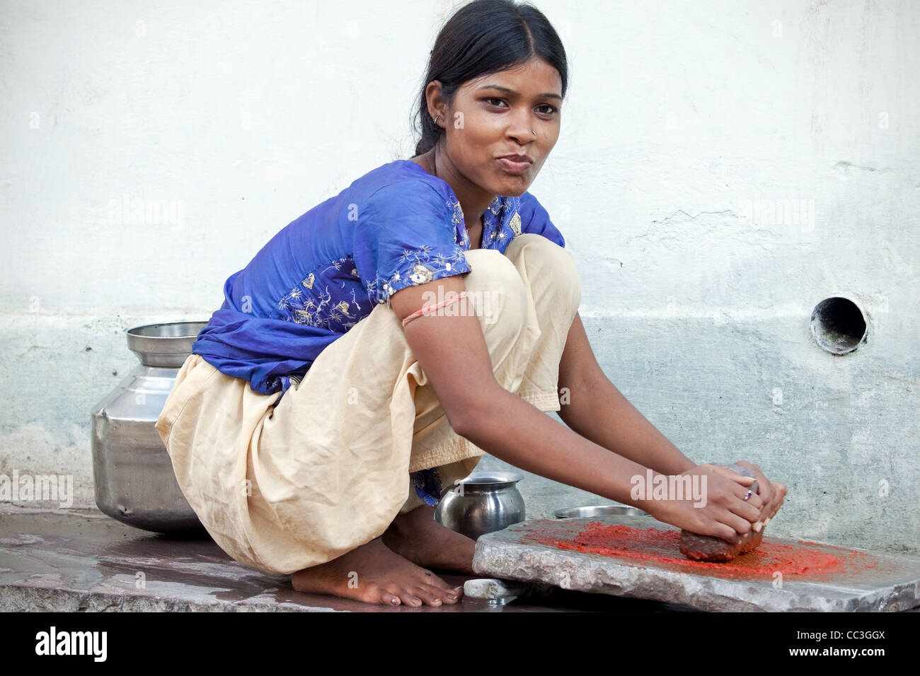 Making chilli paste the traditional way with grinding stone. Domestic ...