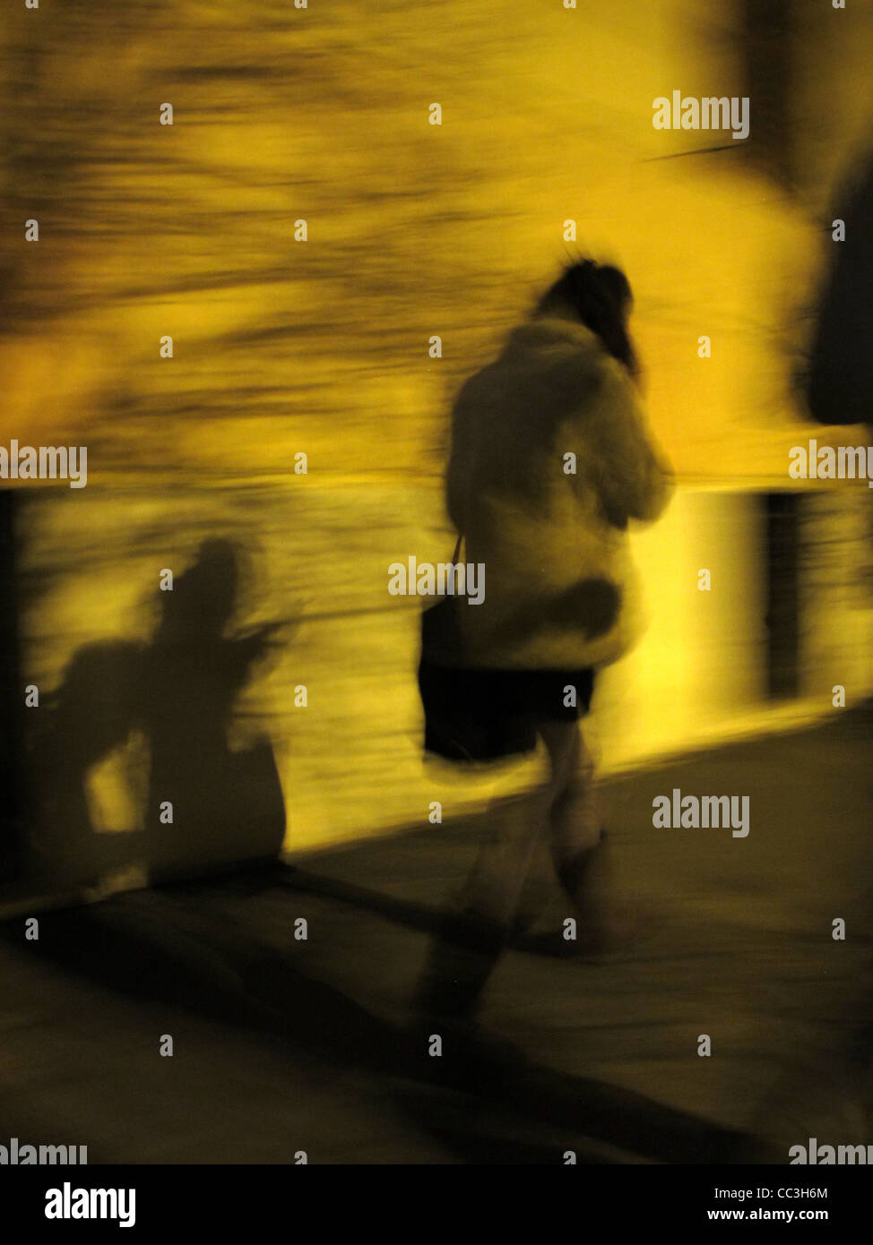 shadow of woman walking in street at night Stock Photo - Alamy