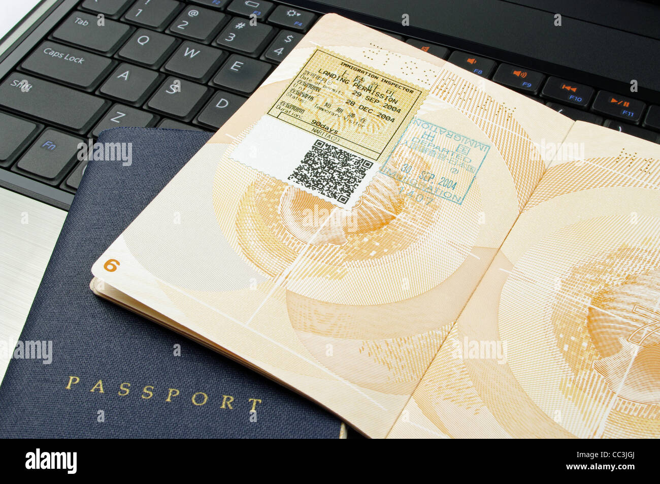 open passport and computer Stock Photo - Alamy