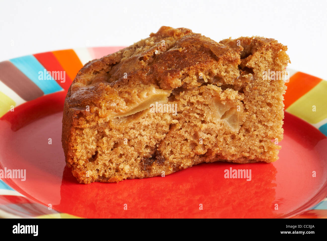 Slice of Herman German friendship cake on red plate Stock Photo - Alamy
