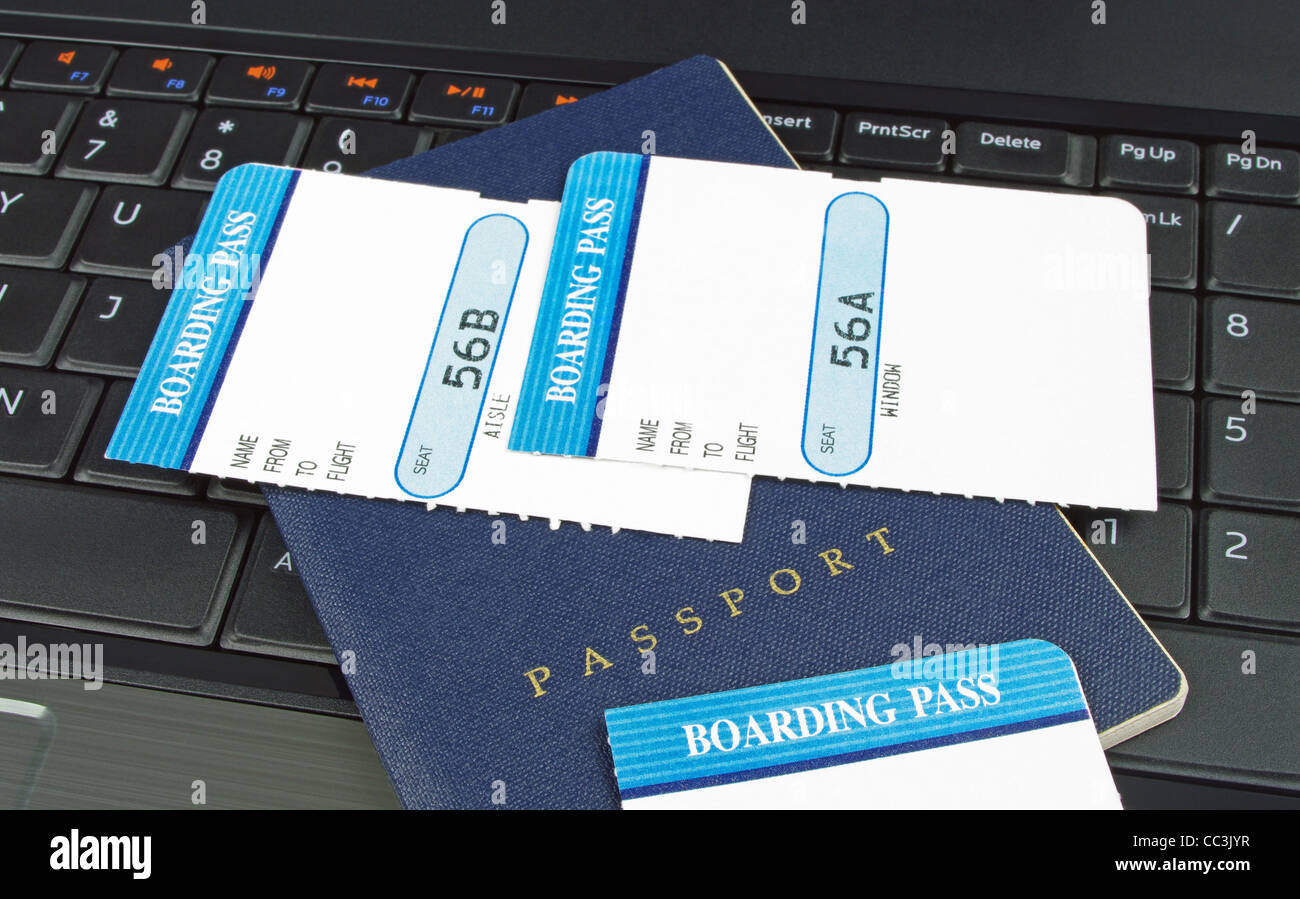 passport with boarding passes on a computer keyboard Stock Photo - Alamy