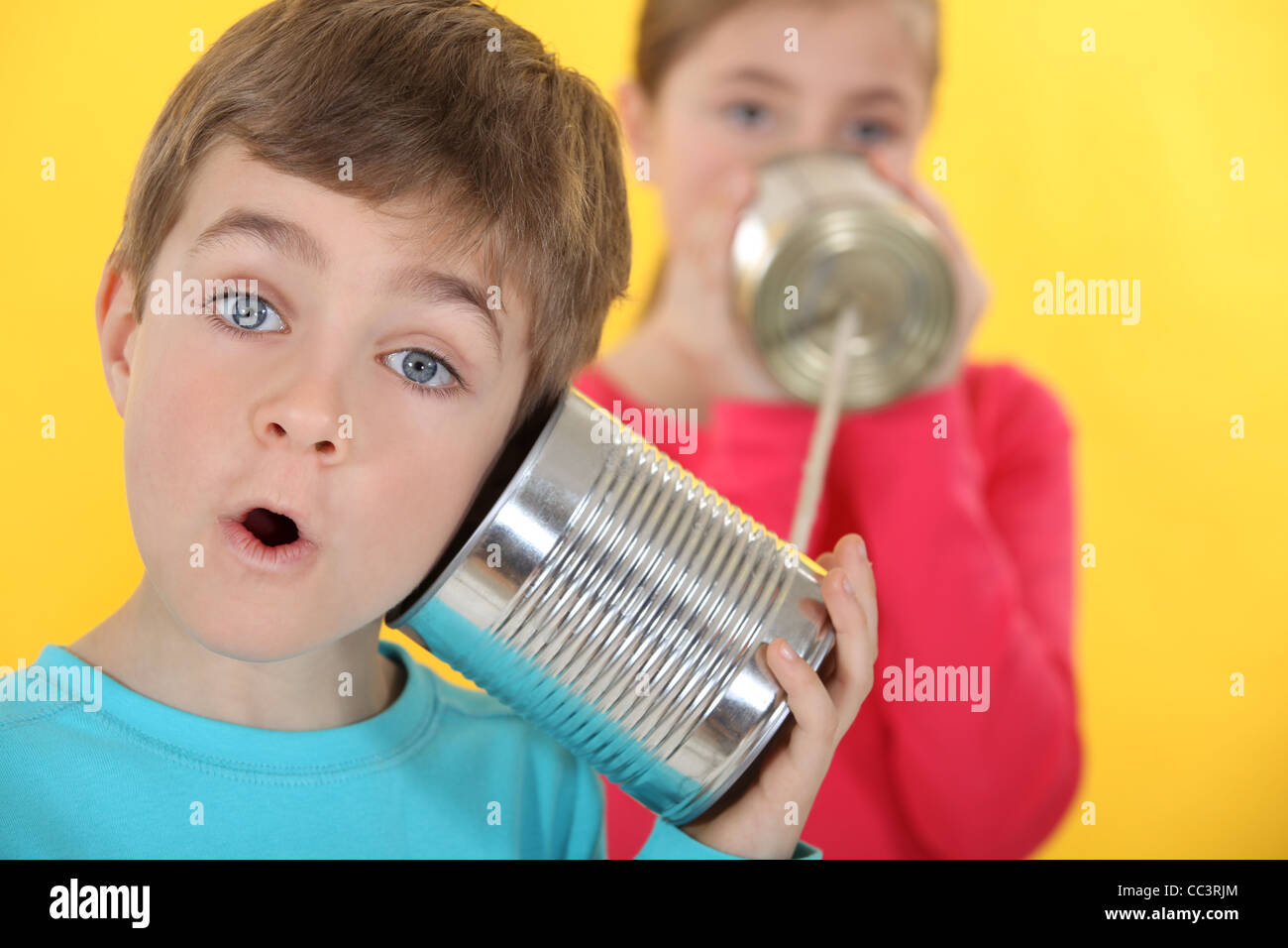 Children communicating with tin cans Stock Photo - Alamy