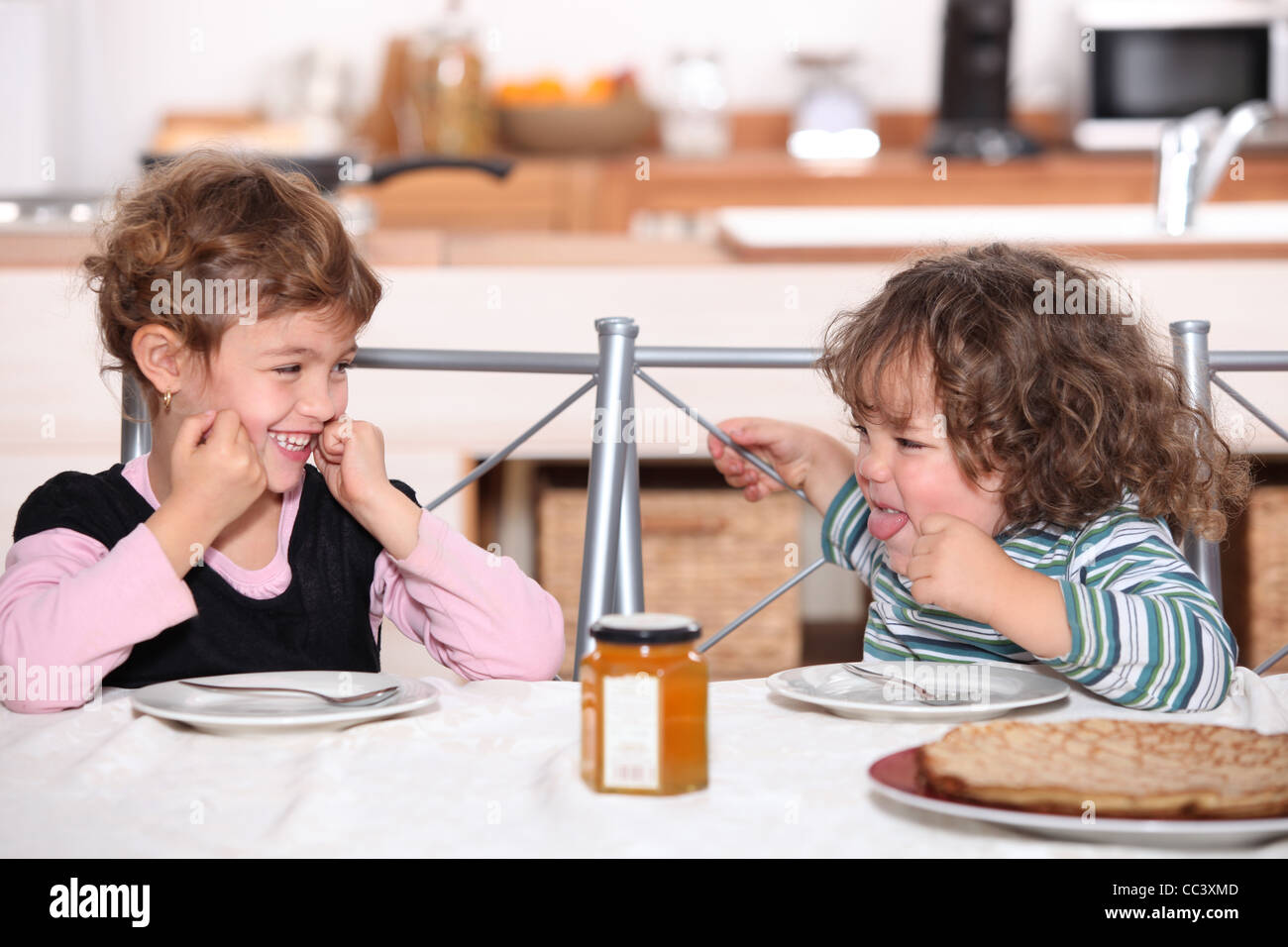 Children pulling faces Stock Photo - Alamy