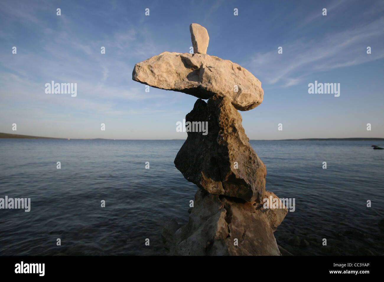 Cross, rocks stacked one one top of another on beach Stock Photo - Alamy