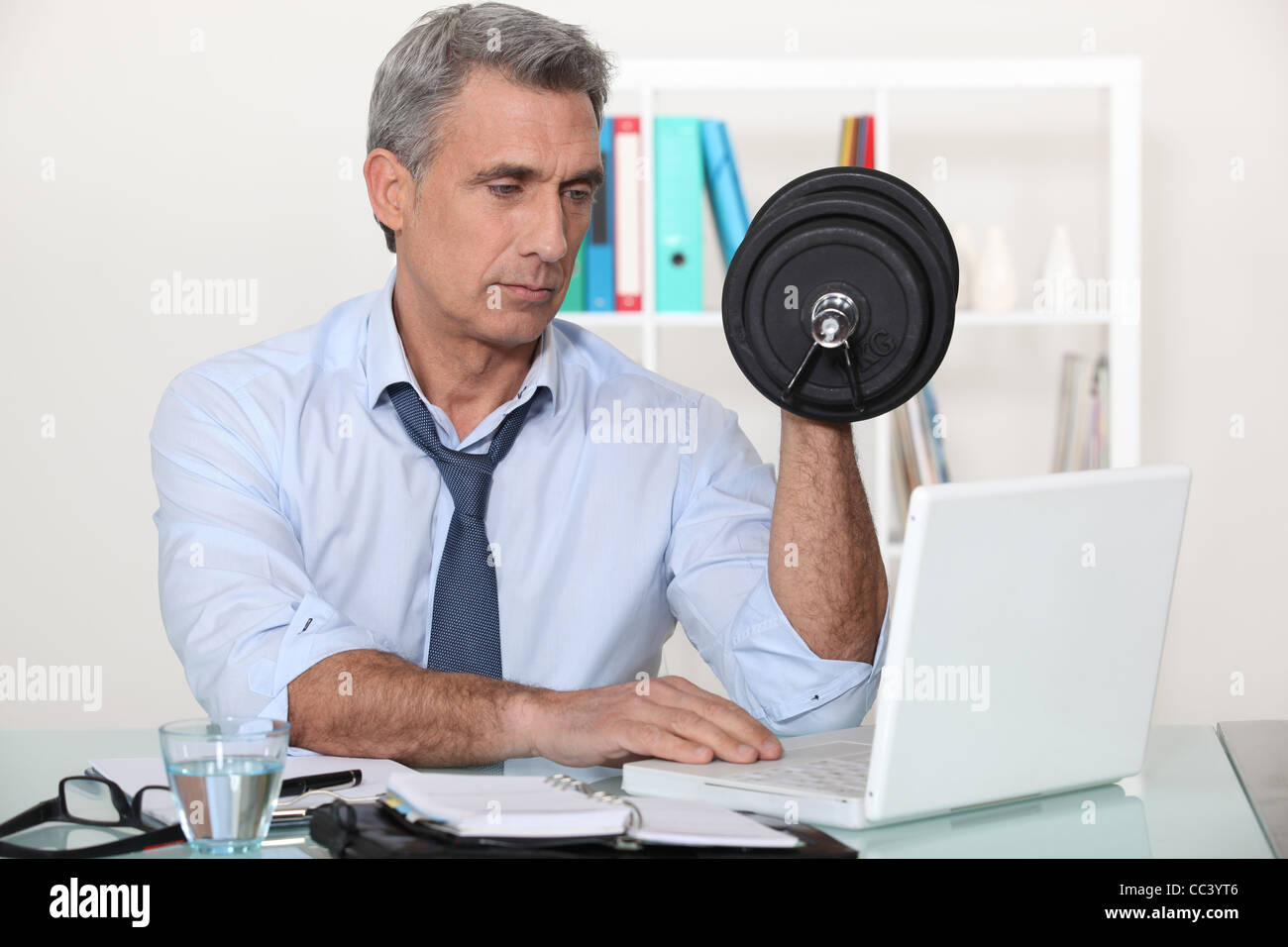 Office worker at desk weight lifting hi-res stock photography and ...