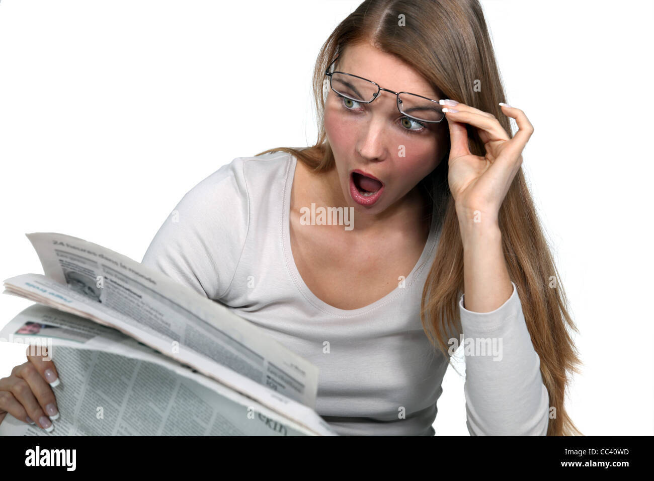 Woman shocked reading newspaper Stock Photo - Alamy