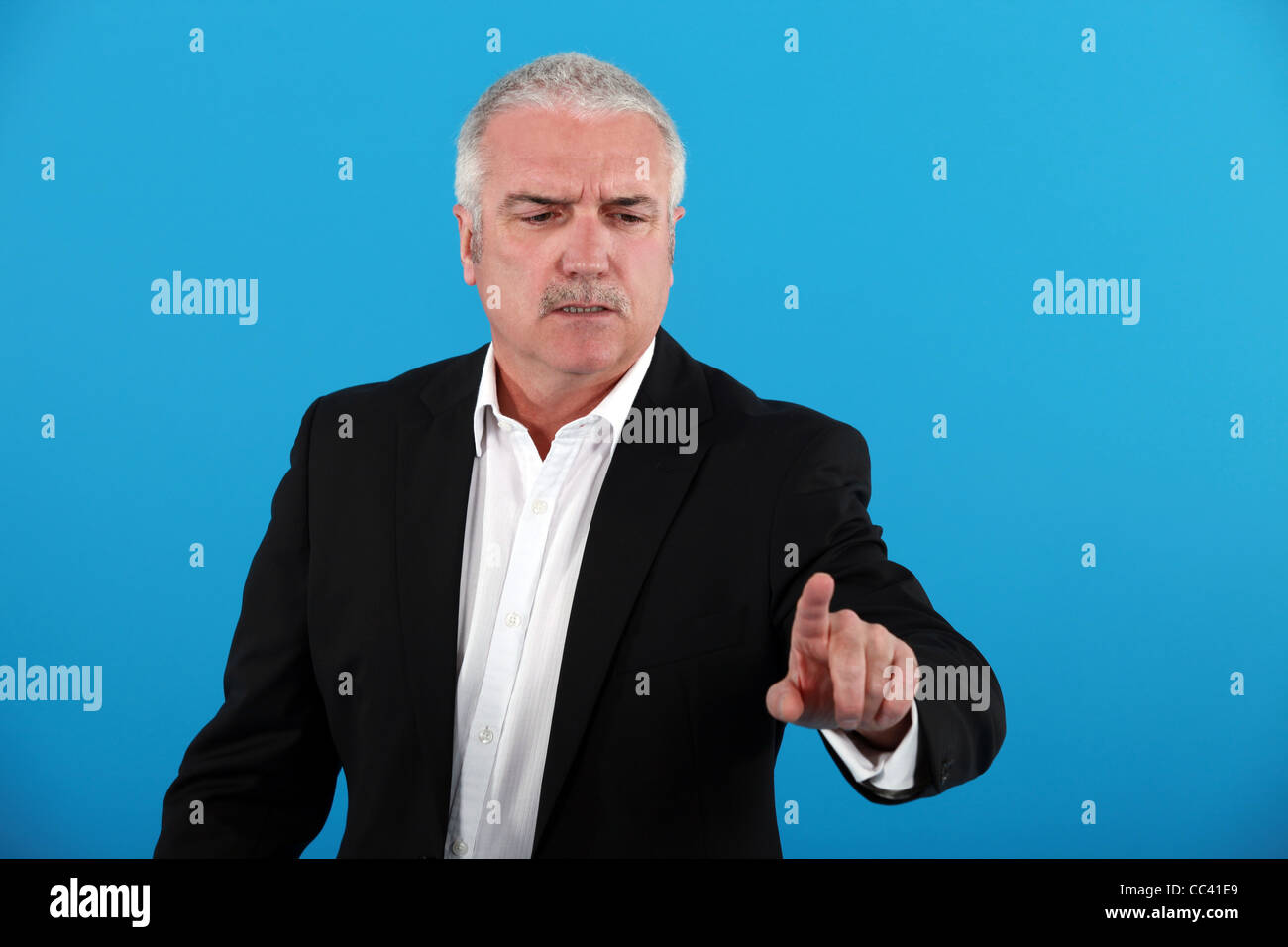 Stern businessman pointing Stock Photo - Alamy