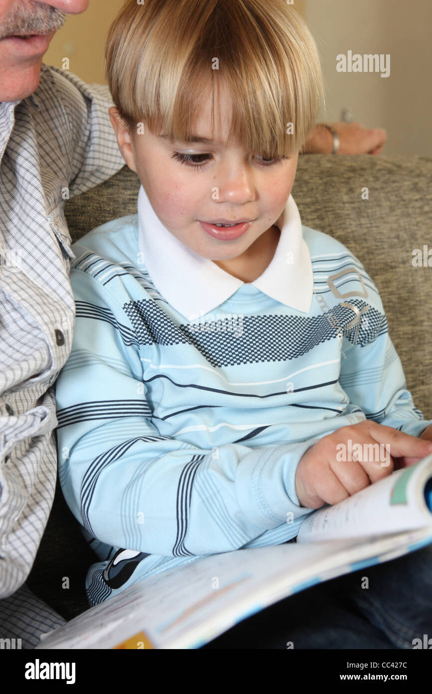 Grandfather reading a book with his grandson Stock Photo - Alamy