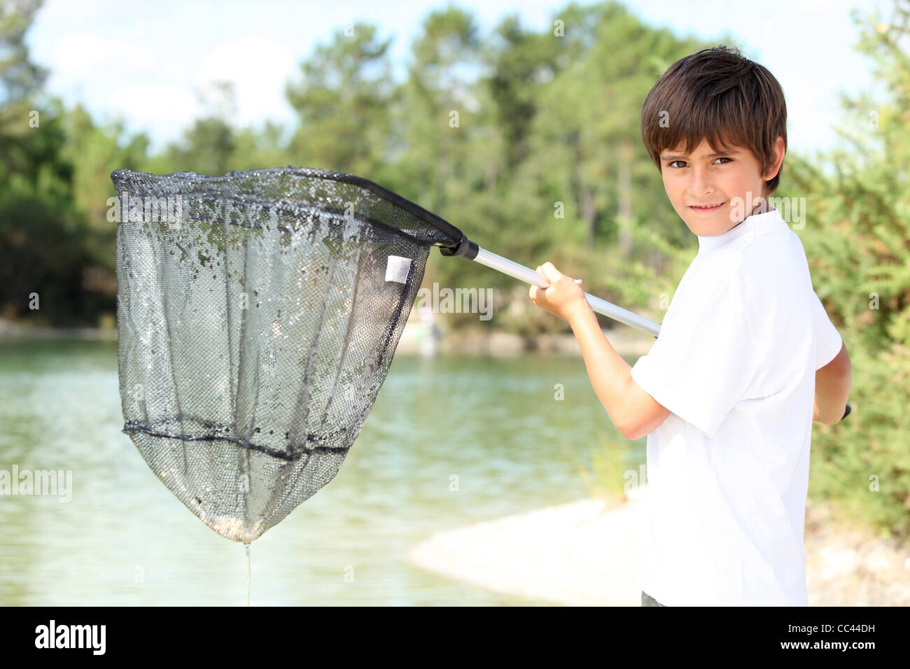 Young boy with a large fishing net Stock Photo - Alamy