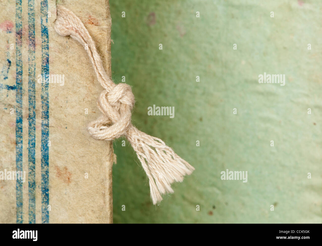 Old tattered folder tied with rope Stock Photo - Alamy
