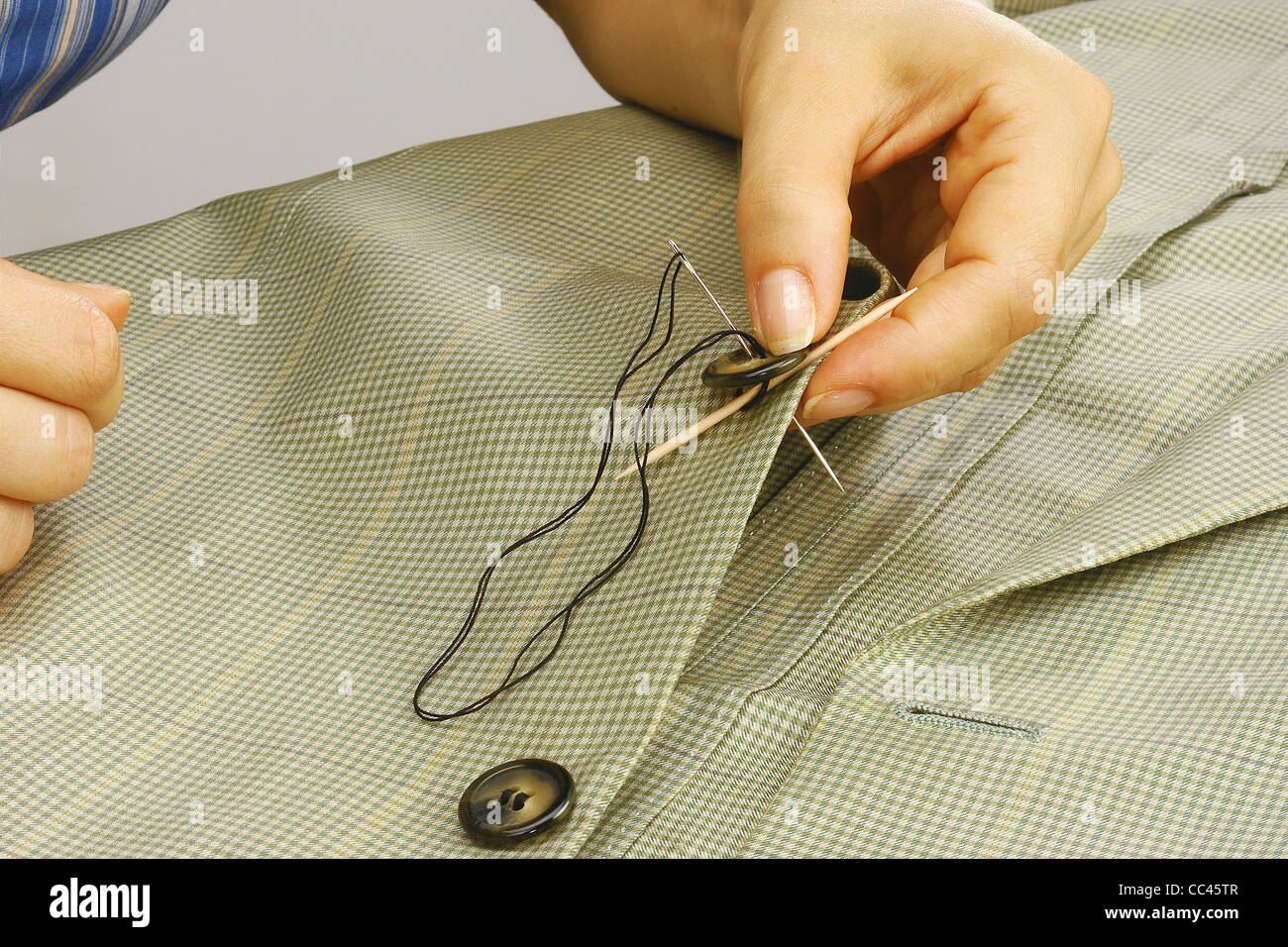 Attaching buttons to tear test hi-res stock photography and images - Alamy