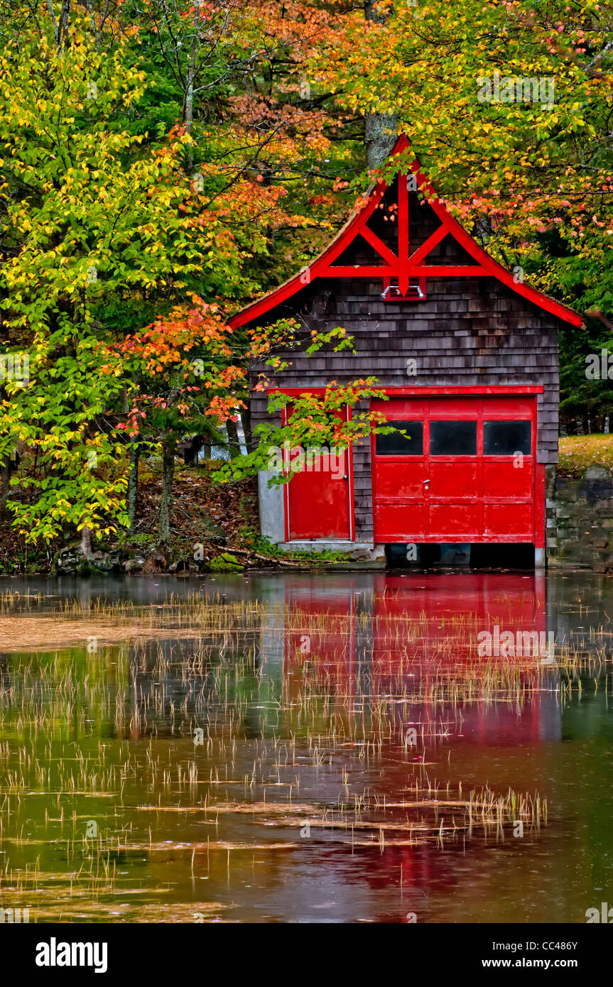 USA, New York, Old Forge. Red boathouse on lake shore. Credit as: Jay O ...