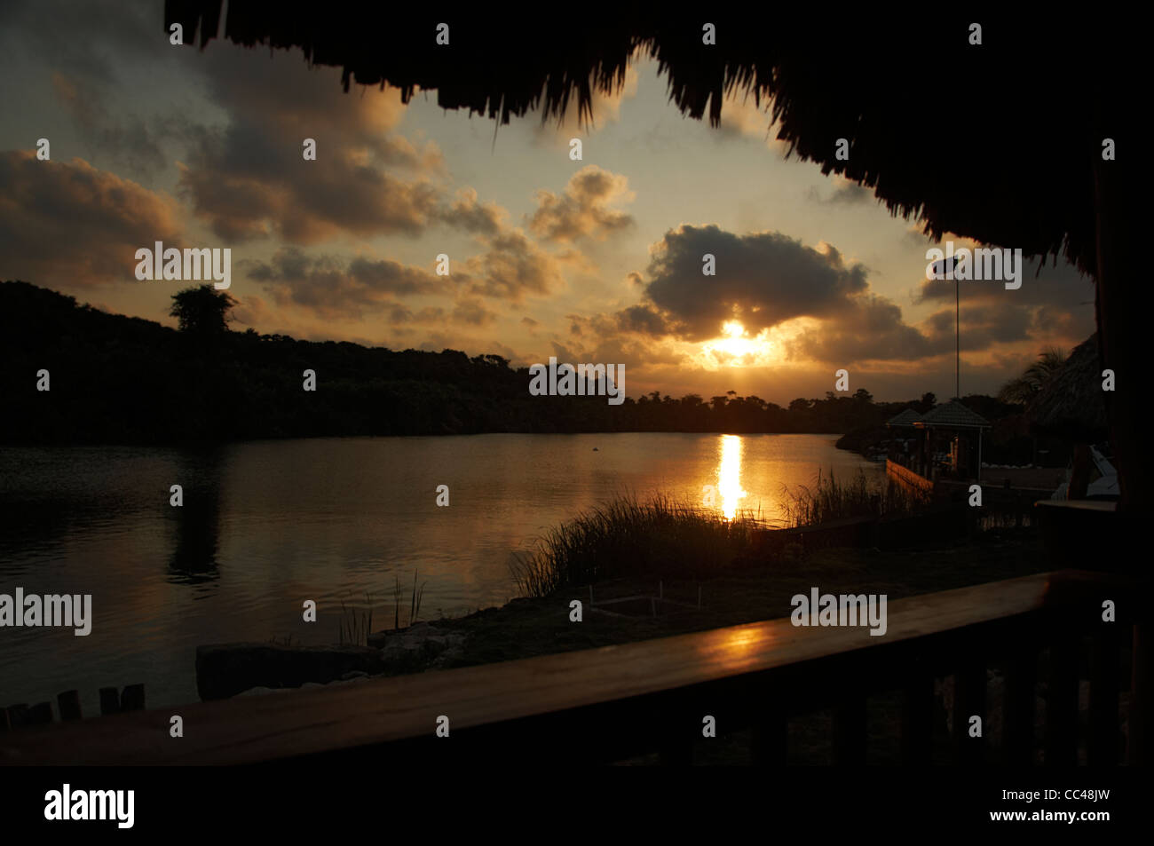 The sun sets and casts a golden glow over Sittee River Stock Photo - Alamy