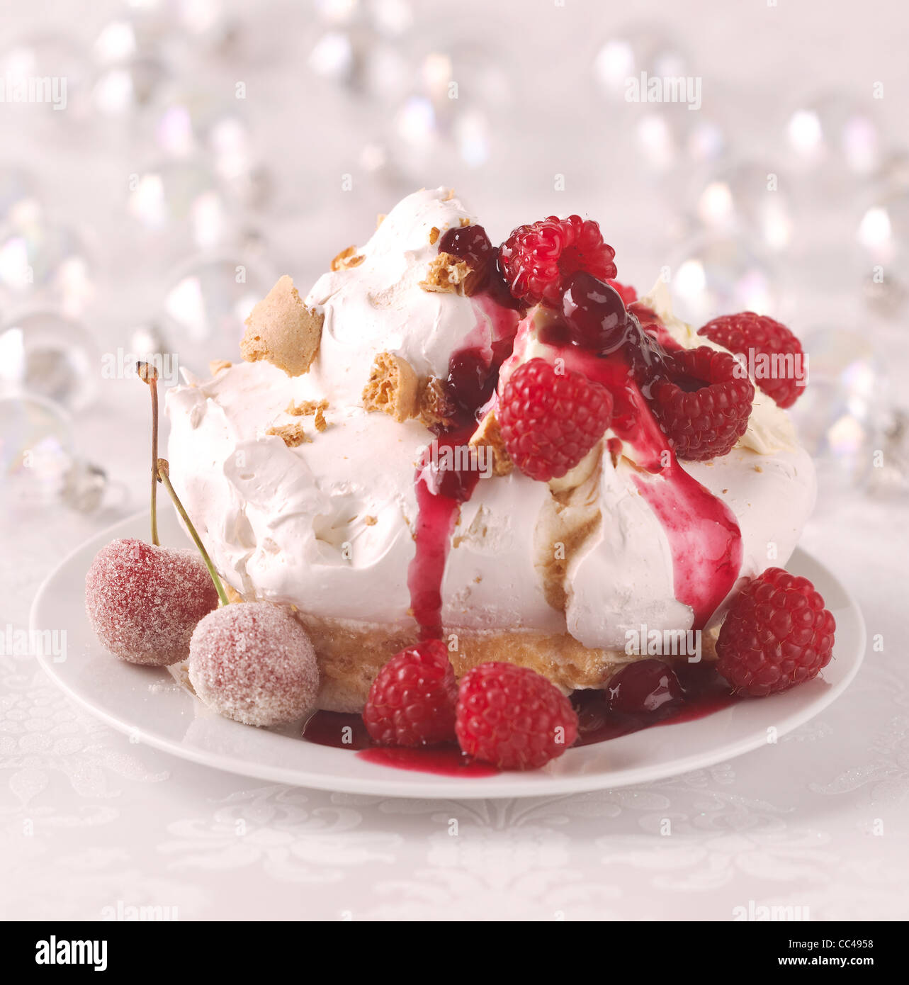 meringue topped with cherry and rasperry coulis Stock Photo - Alamy