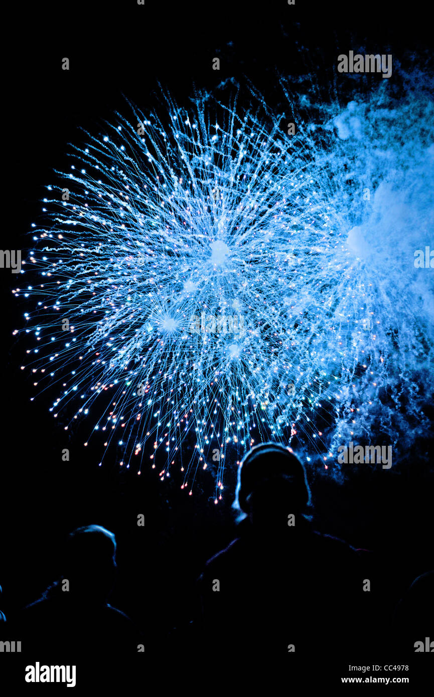 Blue fireworks in a ight sky Stock Photo - Alamy