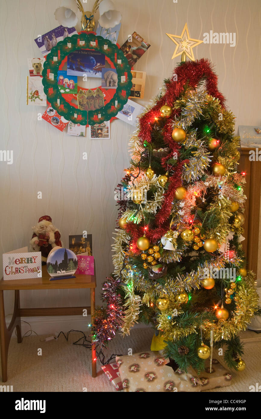 UK Christmas scene with decorated tree with lights and tinsel presents ...