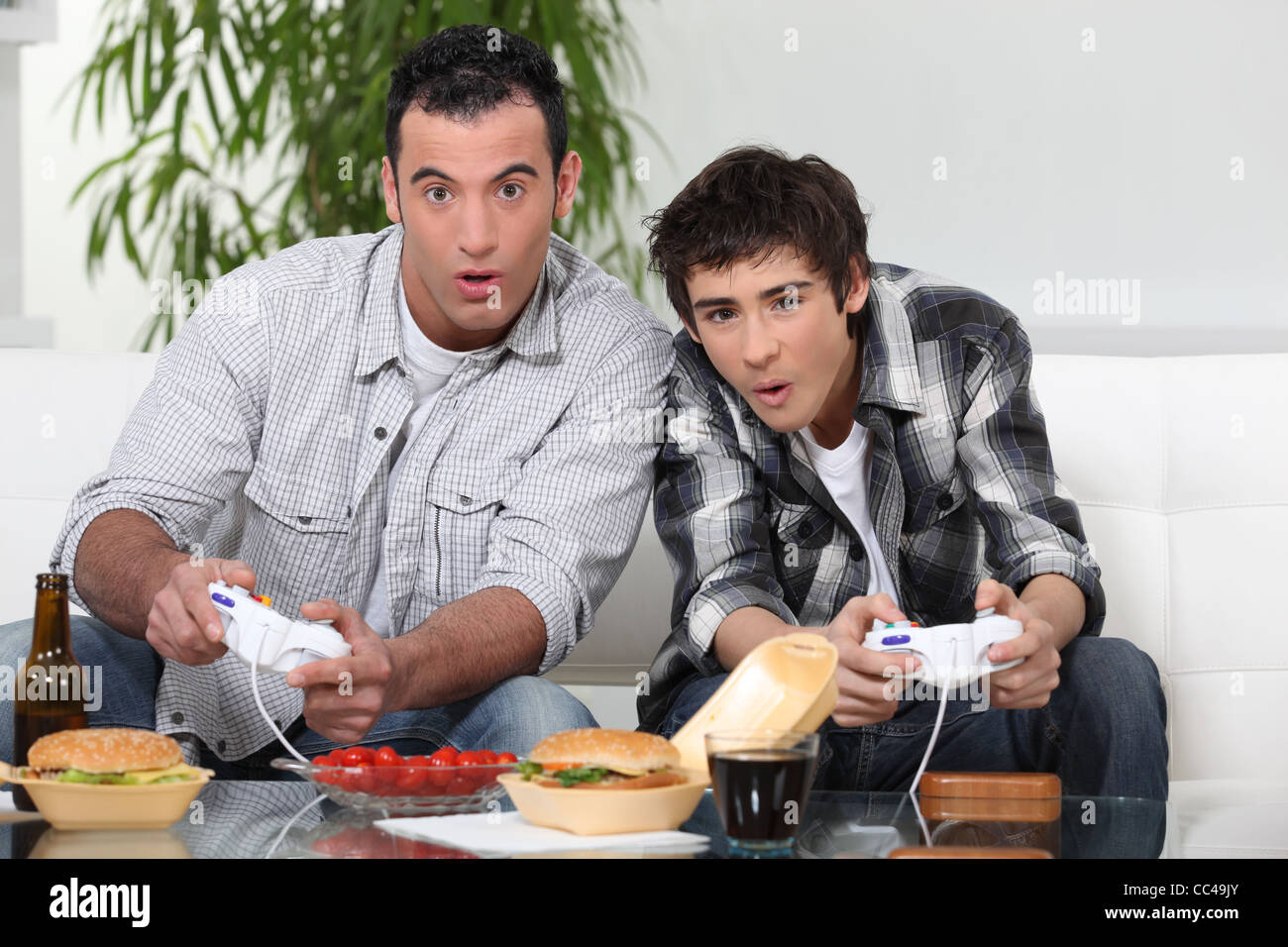 Father and son playing video games Stock Photo - Alamy
